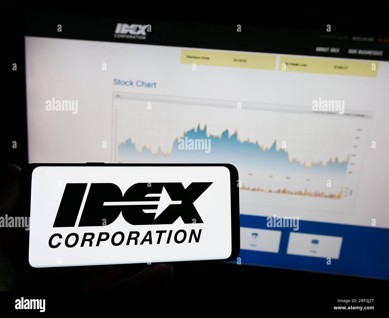 Person holding mobile phone with logo of American manufacturing company ...