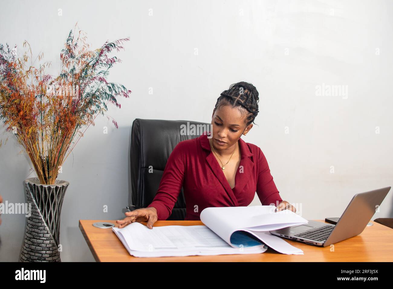 beautiful young african lady busy with work in her office Stock Photo ...
