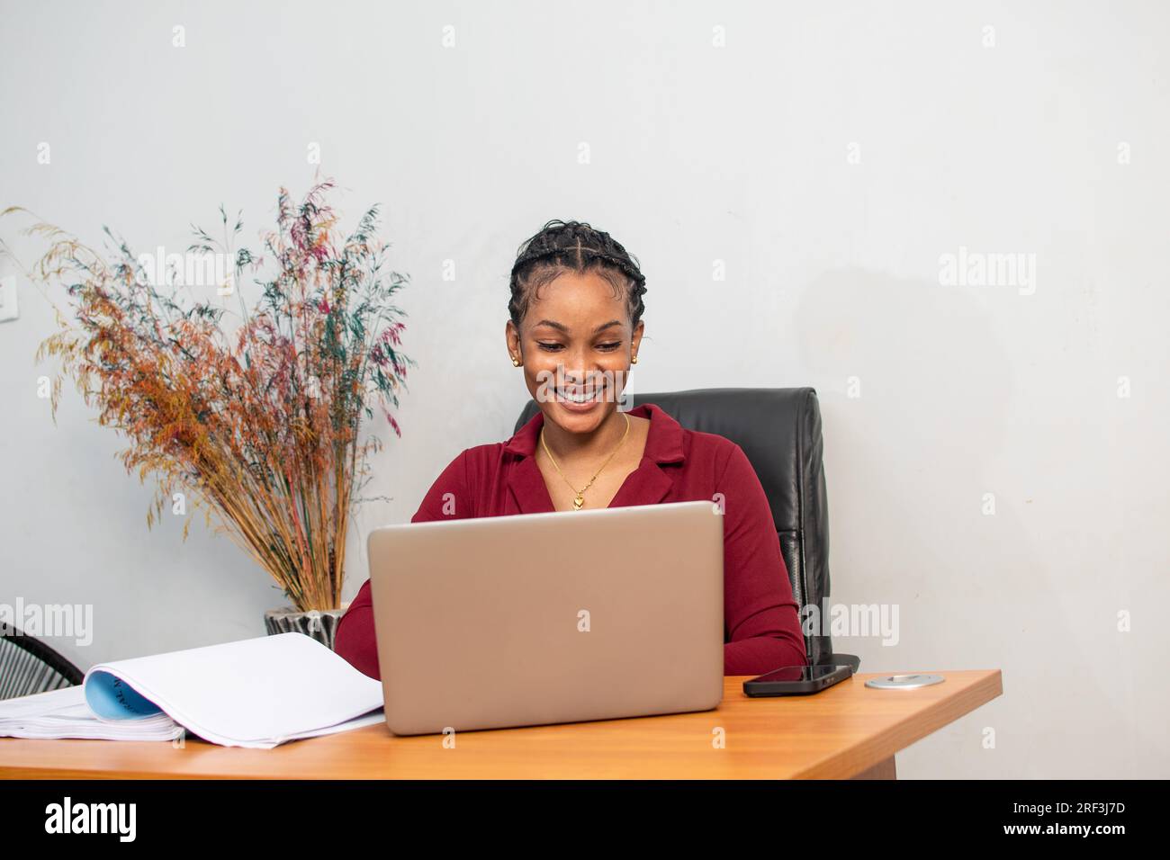 beautiful young african lady at work in her office Stock Photo - Alamy