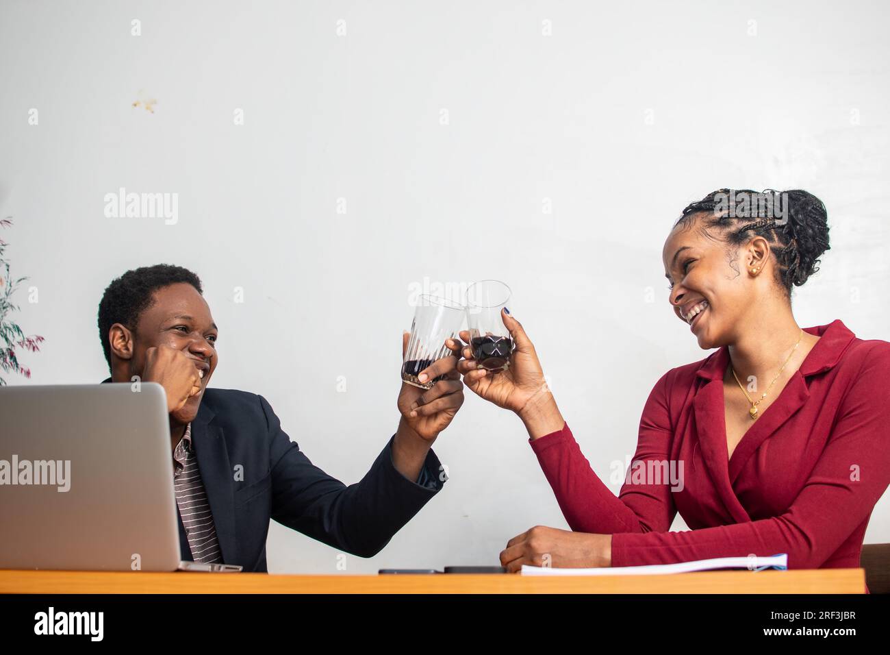 african business colleague make a toast in the office Stock Photo - Alamy