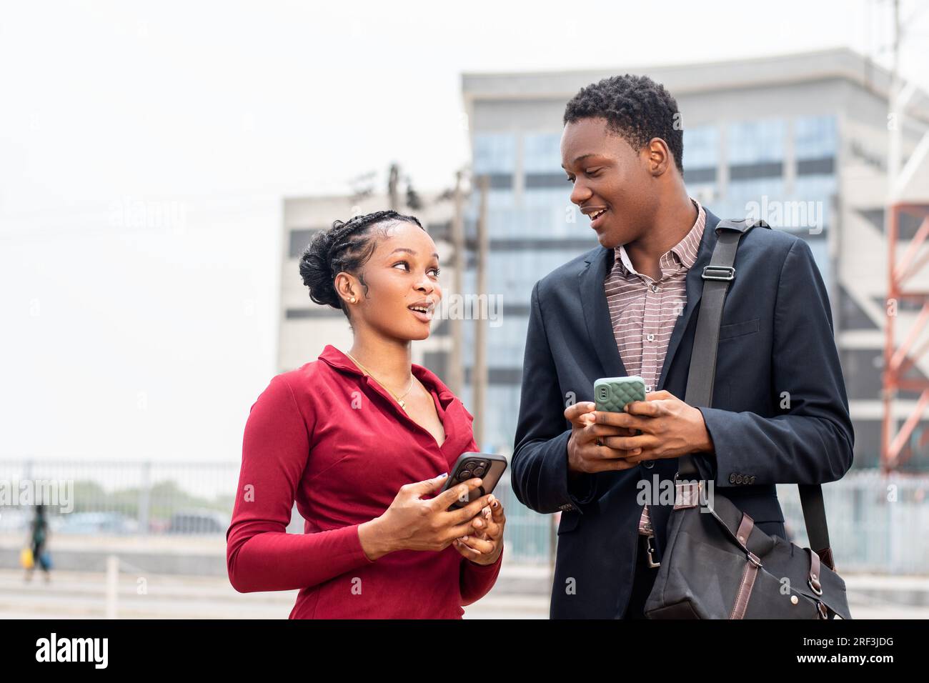 young african business people checking their phone outdoor Stock Photo ...