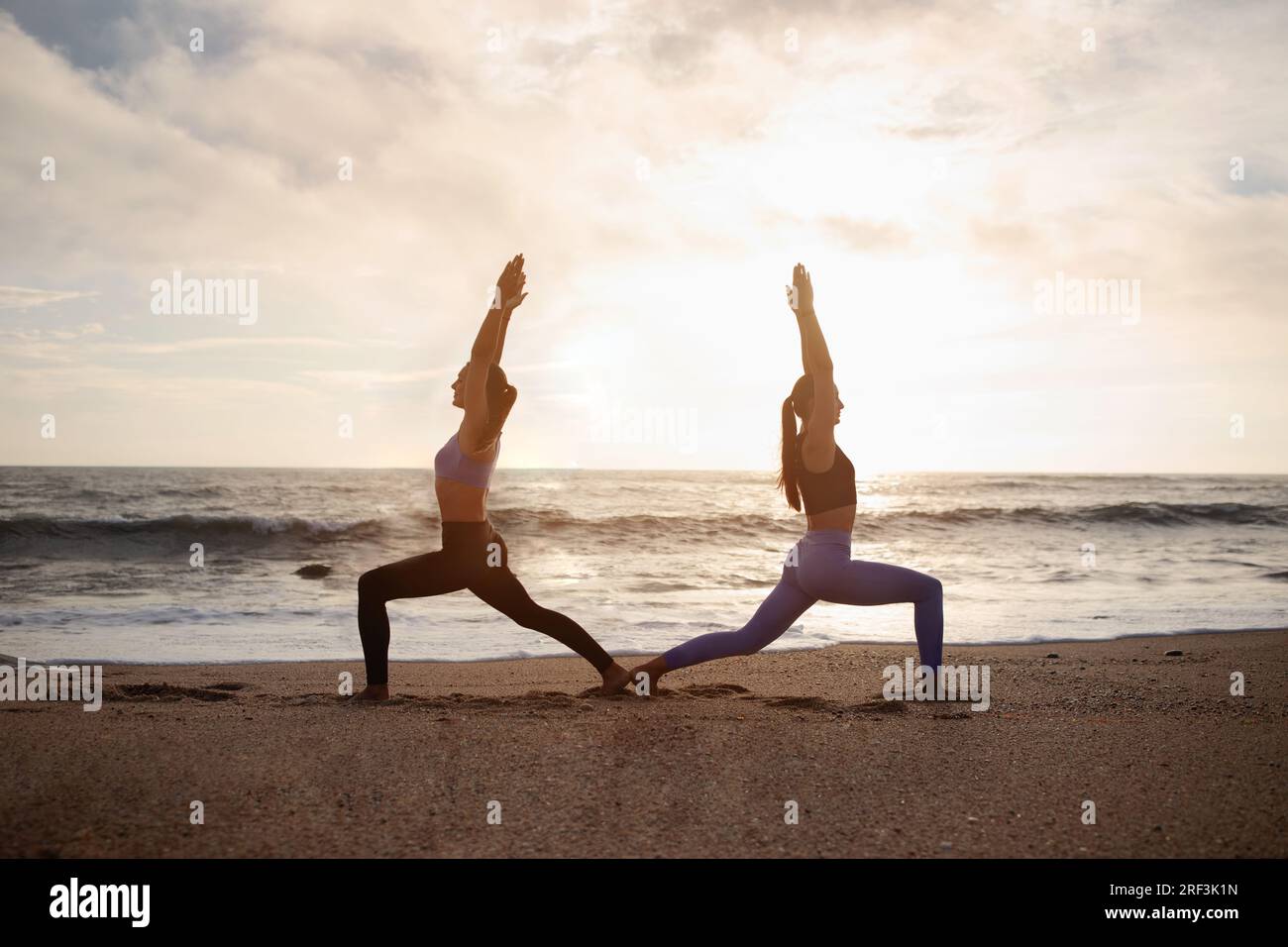 Serious concentrated millennial caucasian twins sisters women practice ...