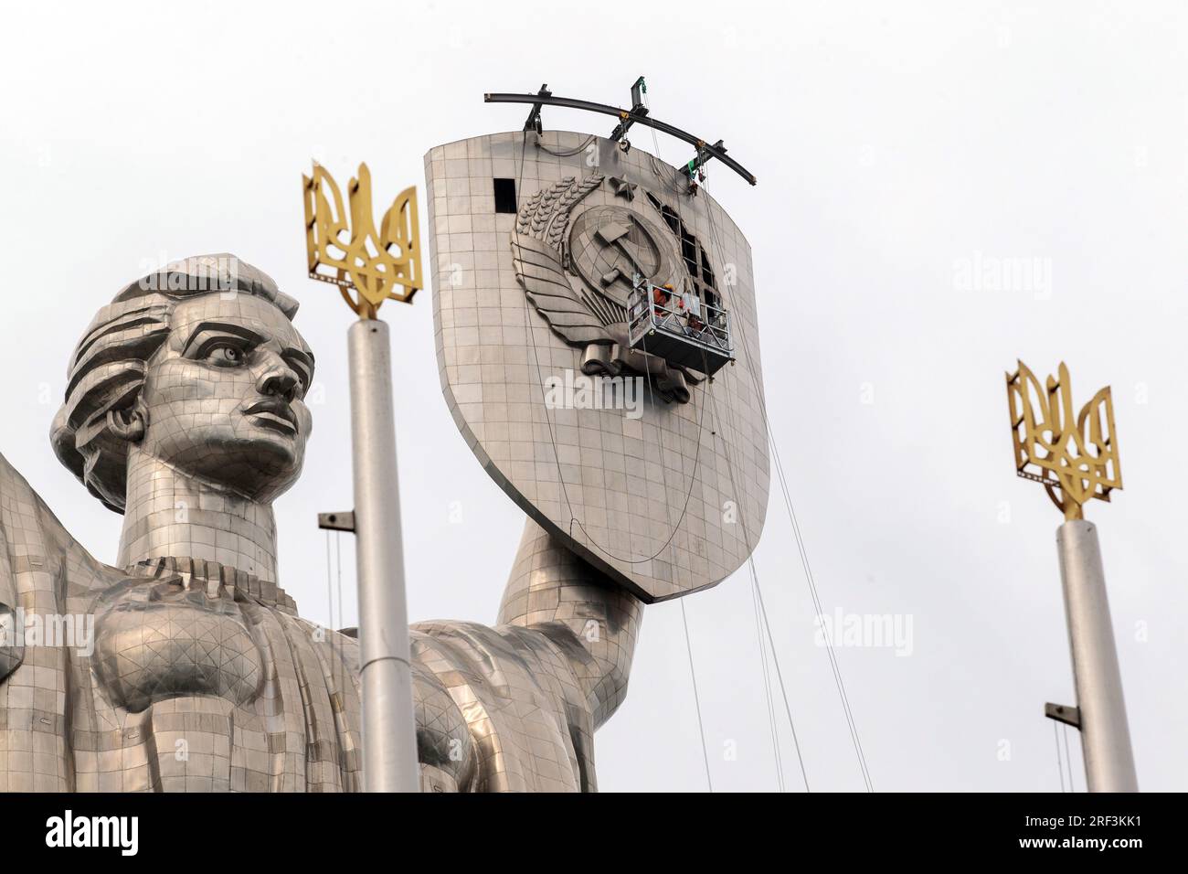 KYIV, UKRAINE - JULY 31, 2023 - Two flagpoles crowned by the coat of ...