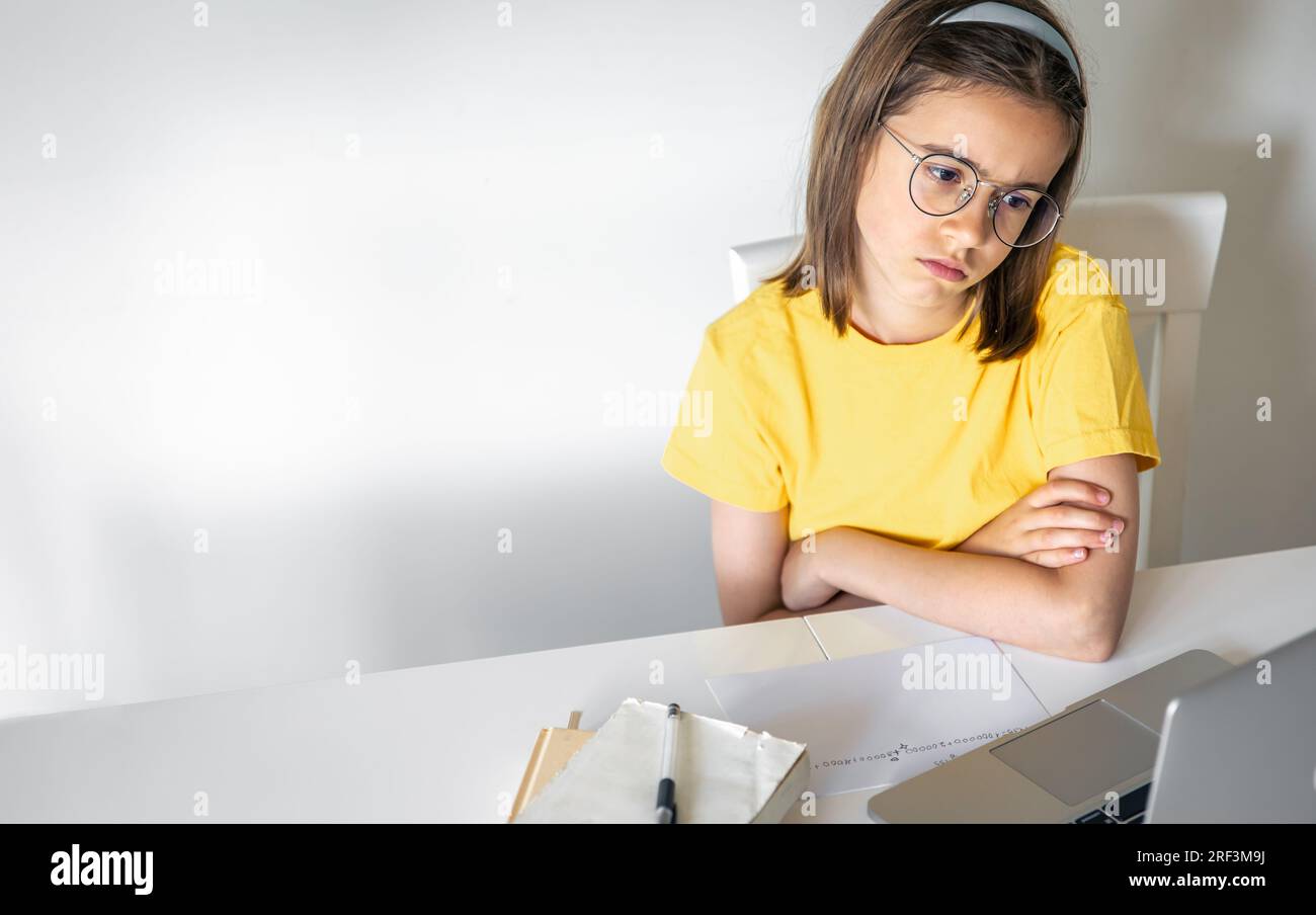 Exhausted schooler girl suffering from doing homework, tired from ...