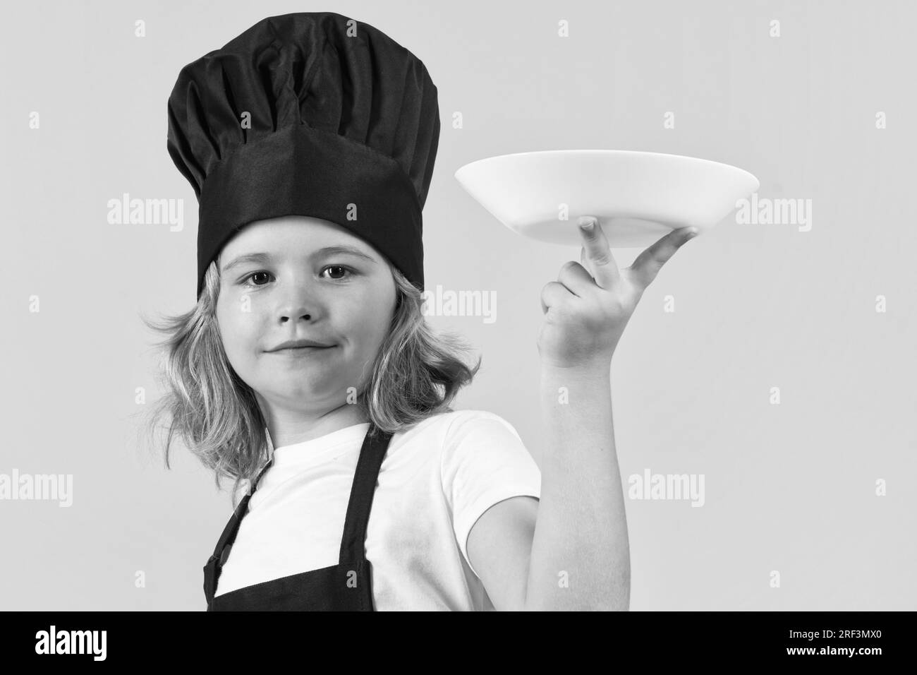 Funny child cook with cooking plate. Child chef cook. Child wearing ... Funny child cook with cooking plate. Child chef cook. Child wearing ...