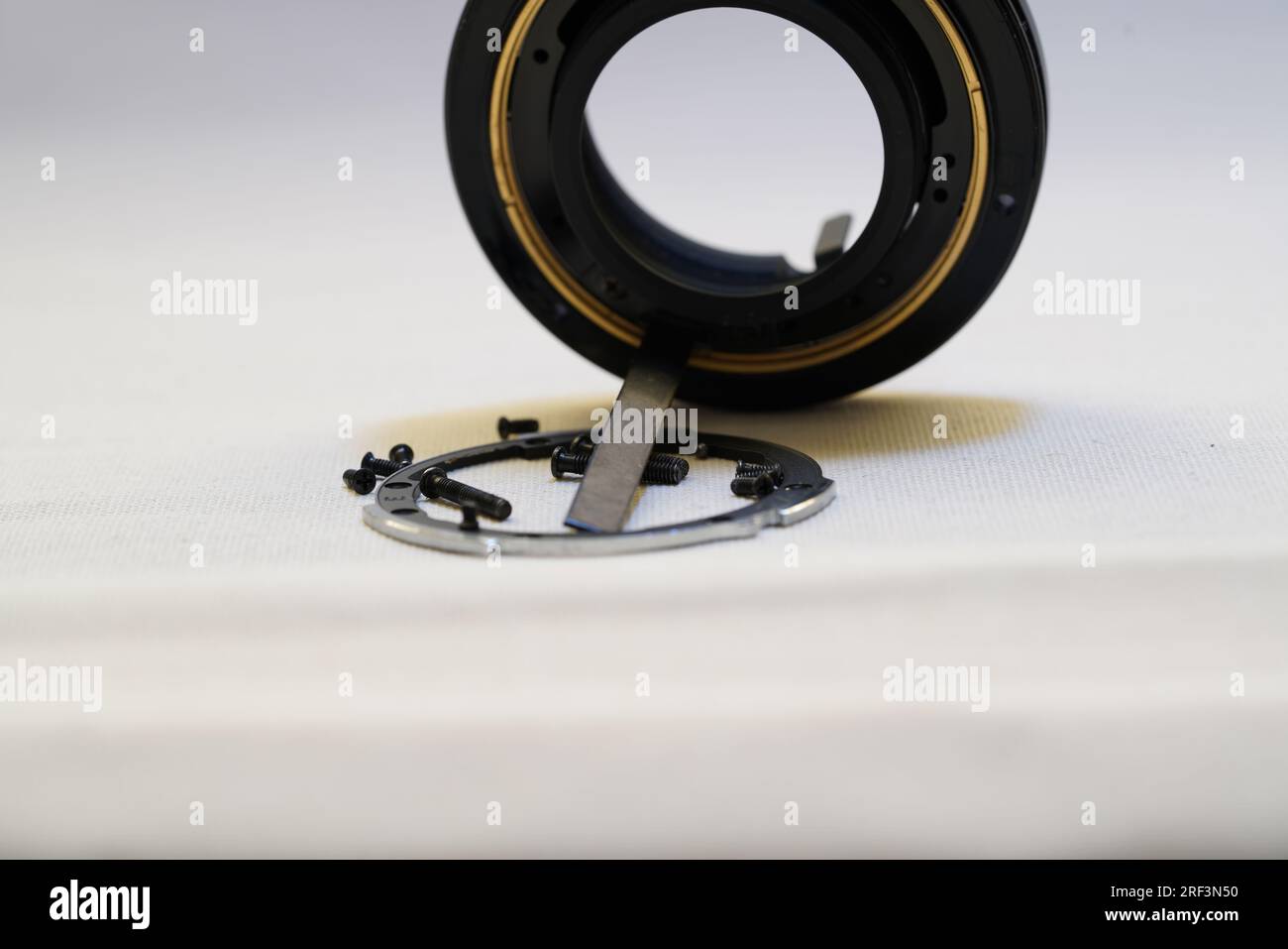 Clean and disassemble the lens for photography into its component parts ...