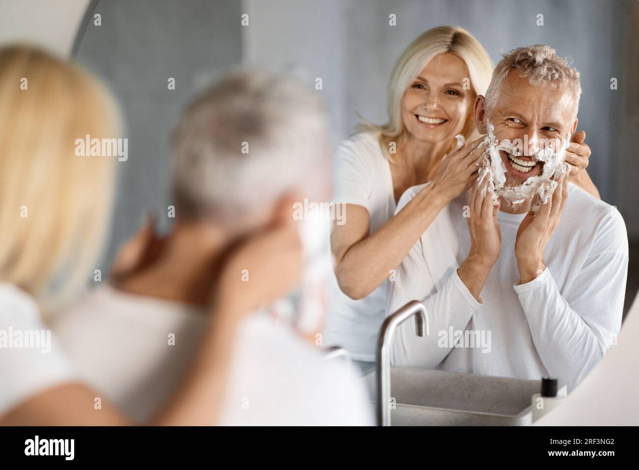 Happy Mature Couple Having Fun While Getting Ready Together In Bathroom ...