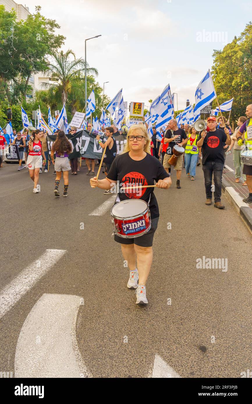 Haifa, Israel - July 29, 2023: People march with various signs under ...