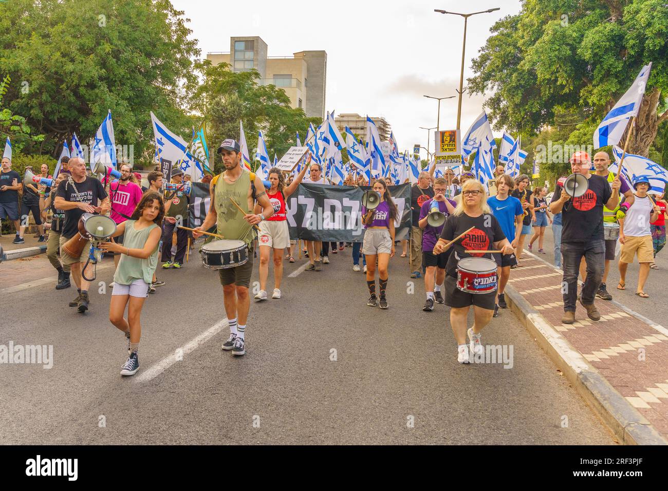 Haifa, Israel - July 29, 2023: People march with various signs under ...