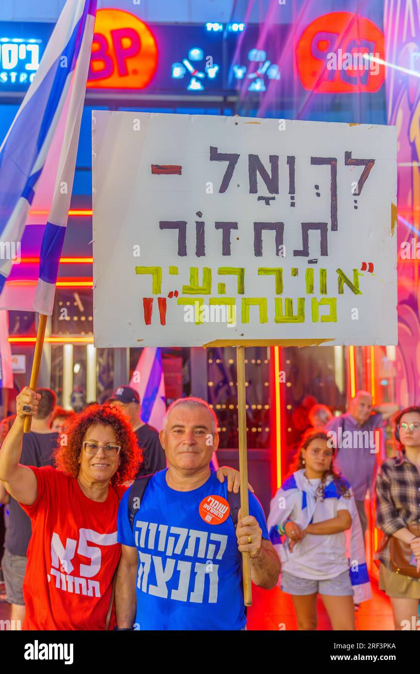 Haifa, Israel - July 29, 2023: People march with various signs under ...