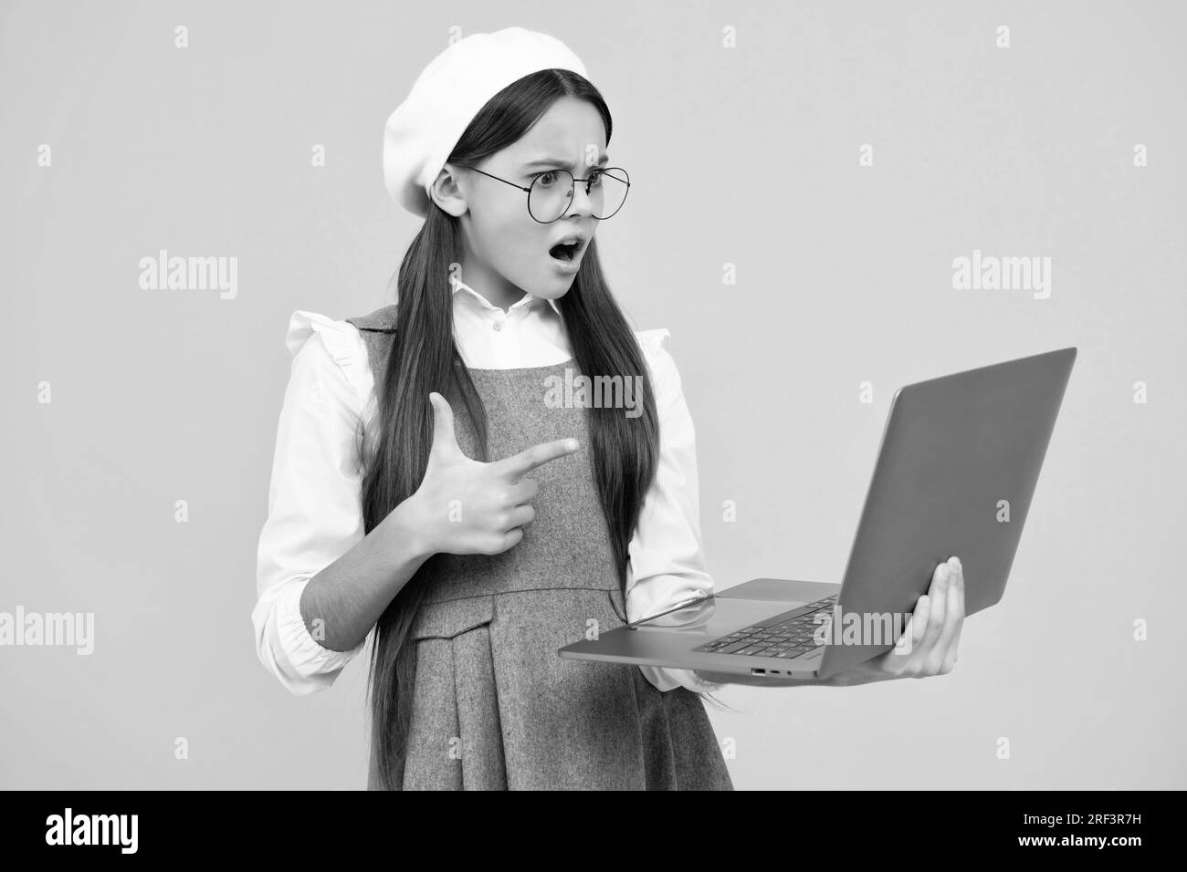 Back to school, Teenager school girl with laptop computer. Angry face ...