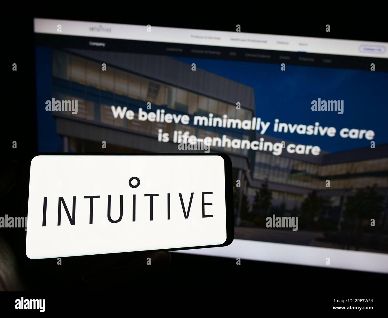 Person holding mobile phone with logo of American medical company ...