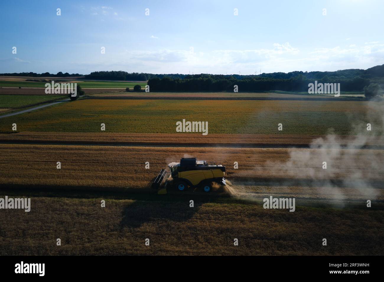 Harvesting machine working at agricultural field. Combine harvester ...