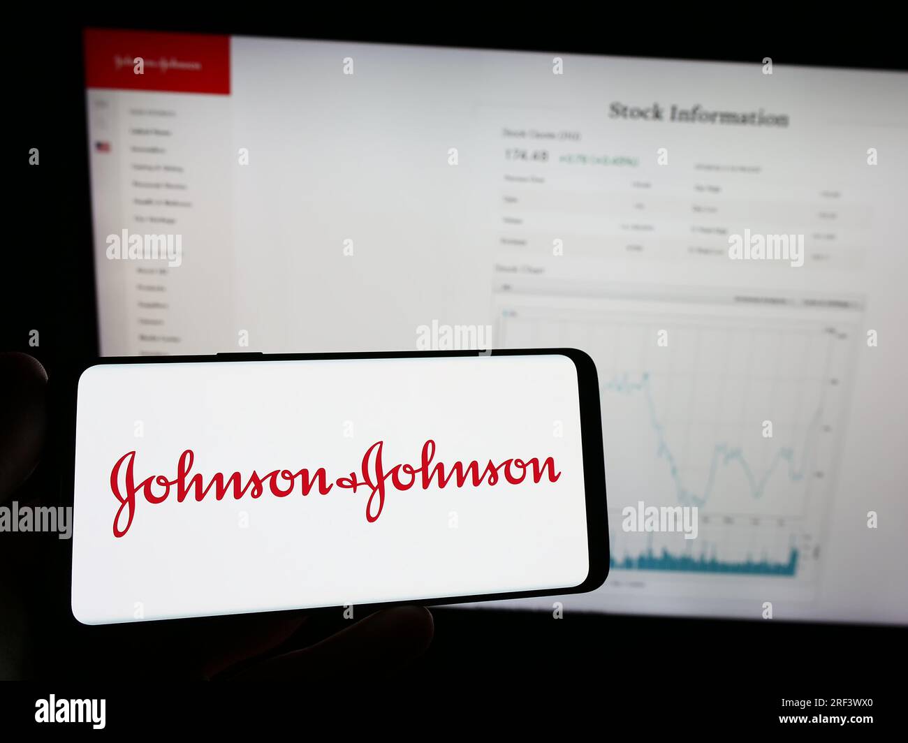 Person holding mobile phone with logo of American company Johnson and ...
