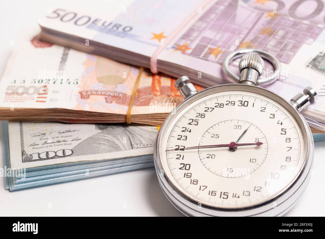 Time is money concept, stopwatch on the euro banknotes Stock Photo - Alamy