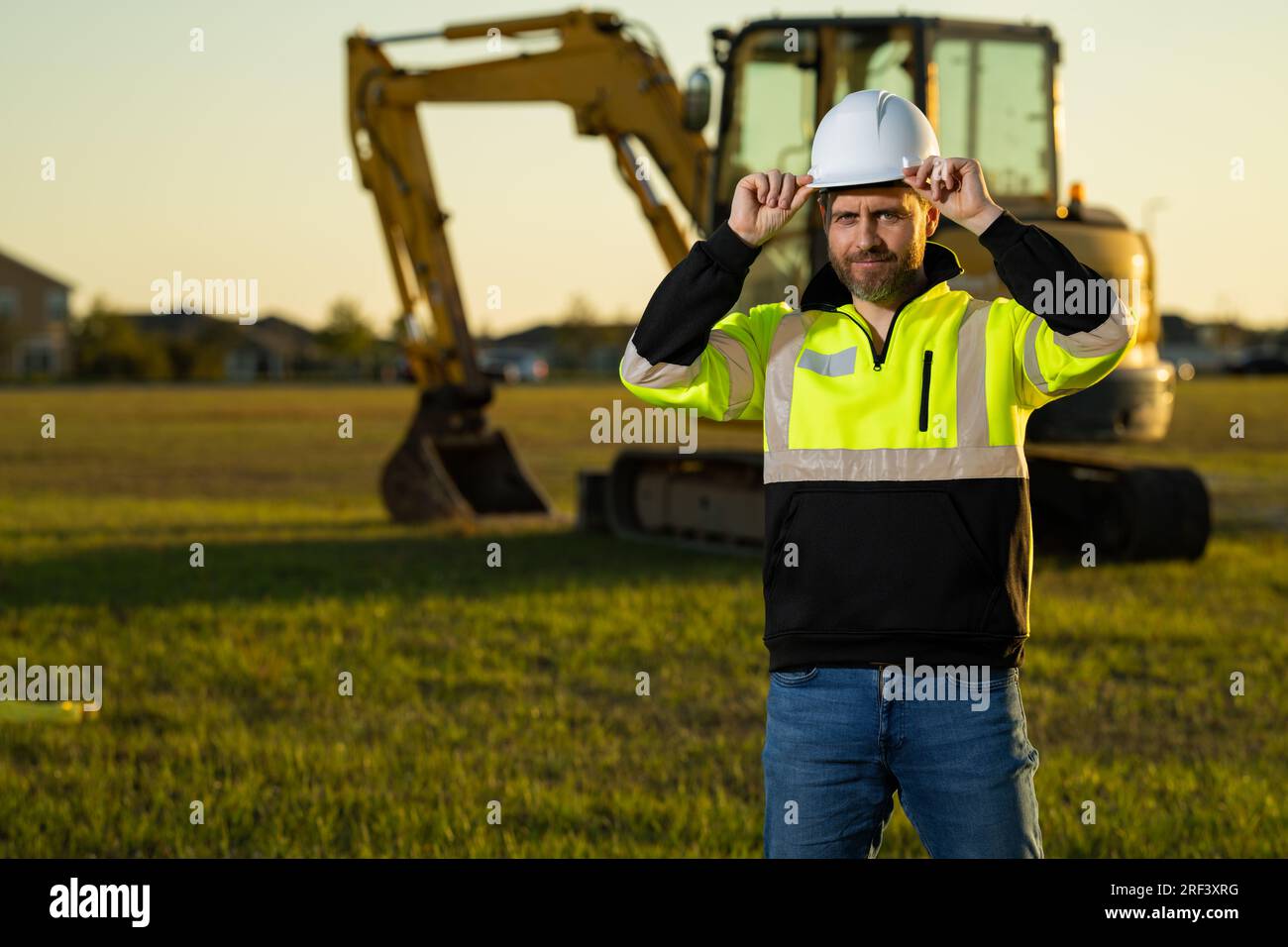 Builder with excavator for construction at the construction site ...