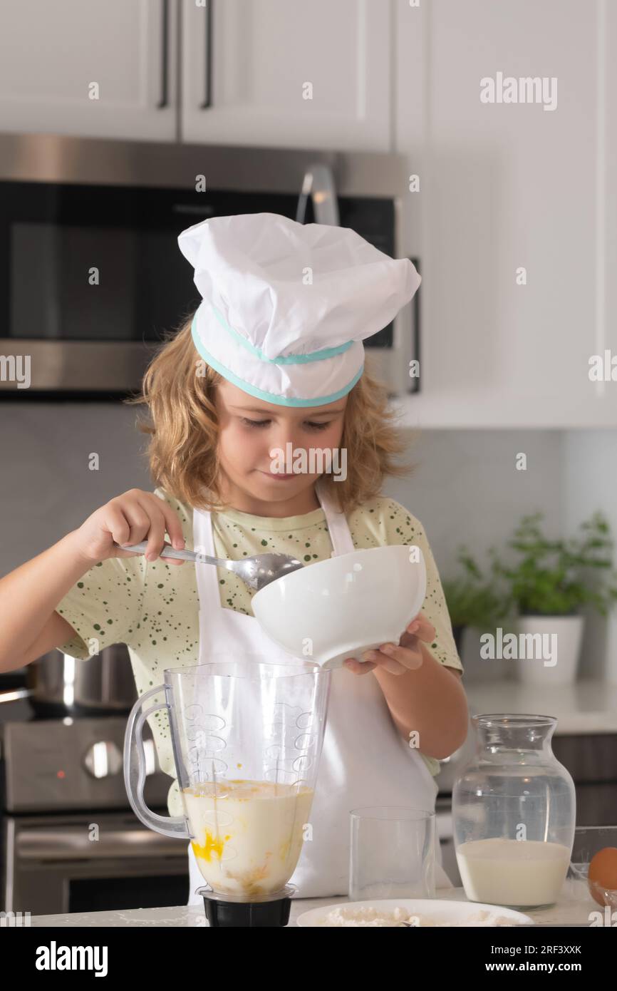 Kid chef cook cookery at kitchen. Portrait of little child in uniform ...