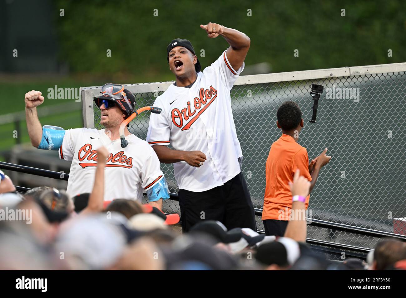 Maryland Governor Wes Moore and son James cheer along with the spray ...