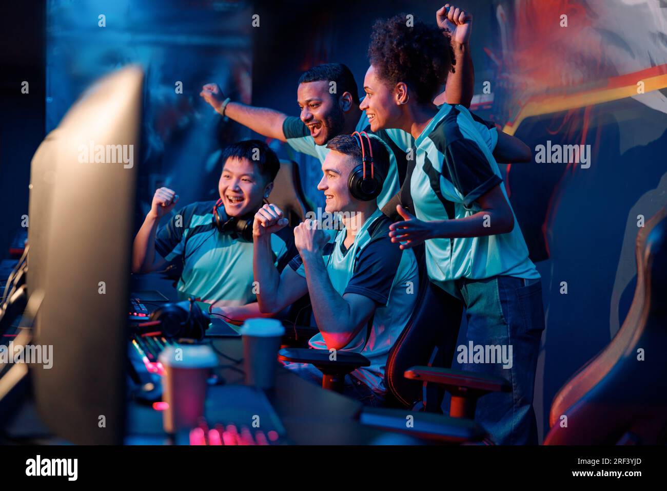 Team of professional cybersport gamers celebrating success in gaming ...