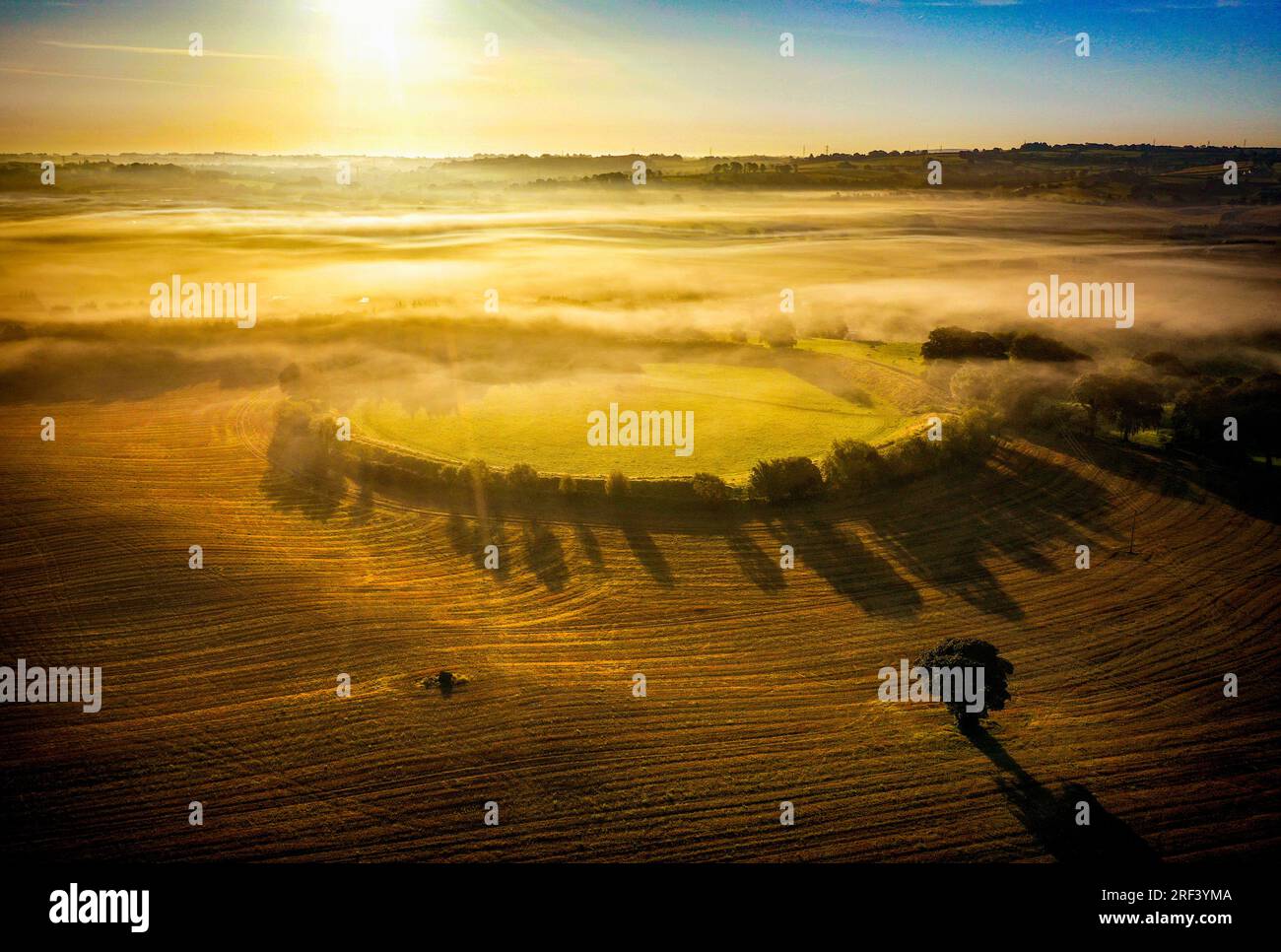 Sunrise through the mist at the Giant's Ring Henge Monument at ...
