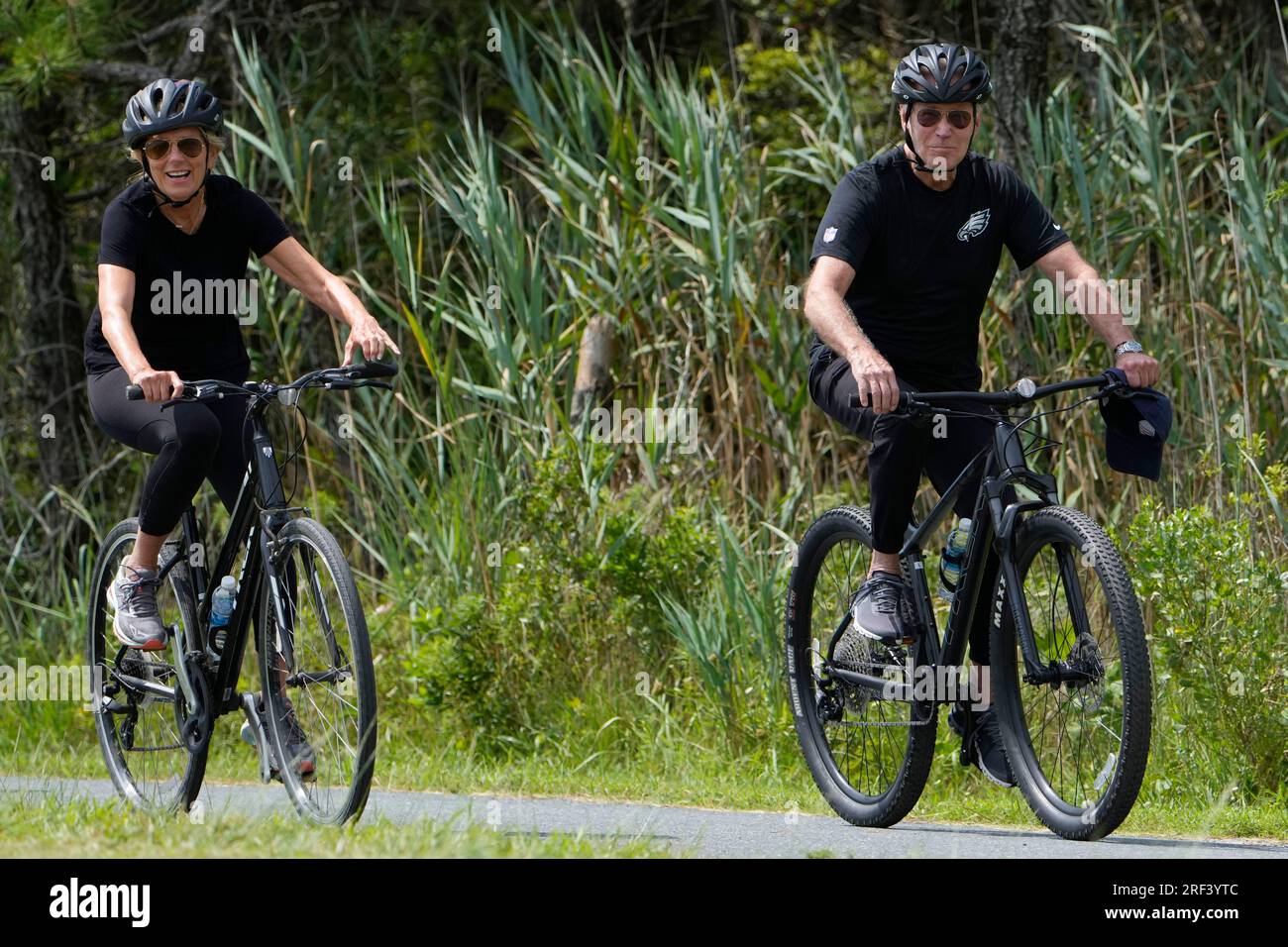 President Joe Biden and first lady Jill Biden ride their bikes at ...