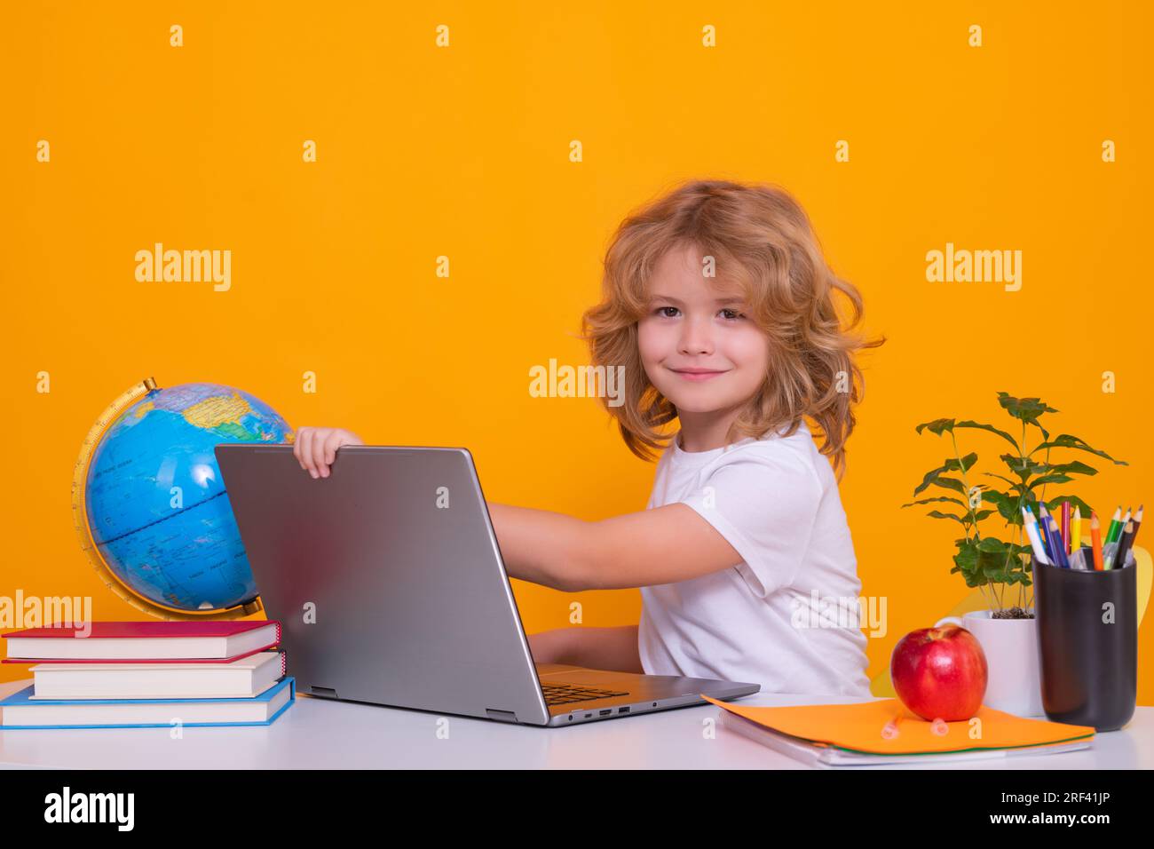 School child using laptop computer. Portrait of cute child school boy ...
