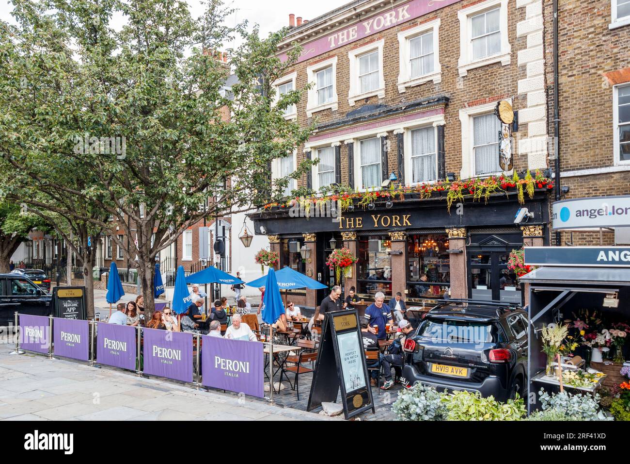 Customers drinking outside The York, a traditional public house on ...