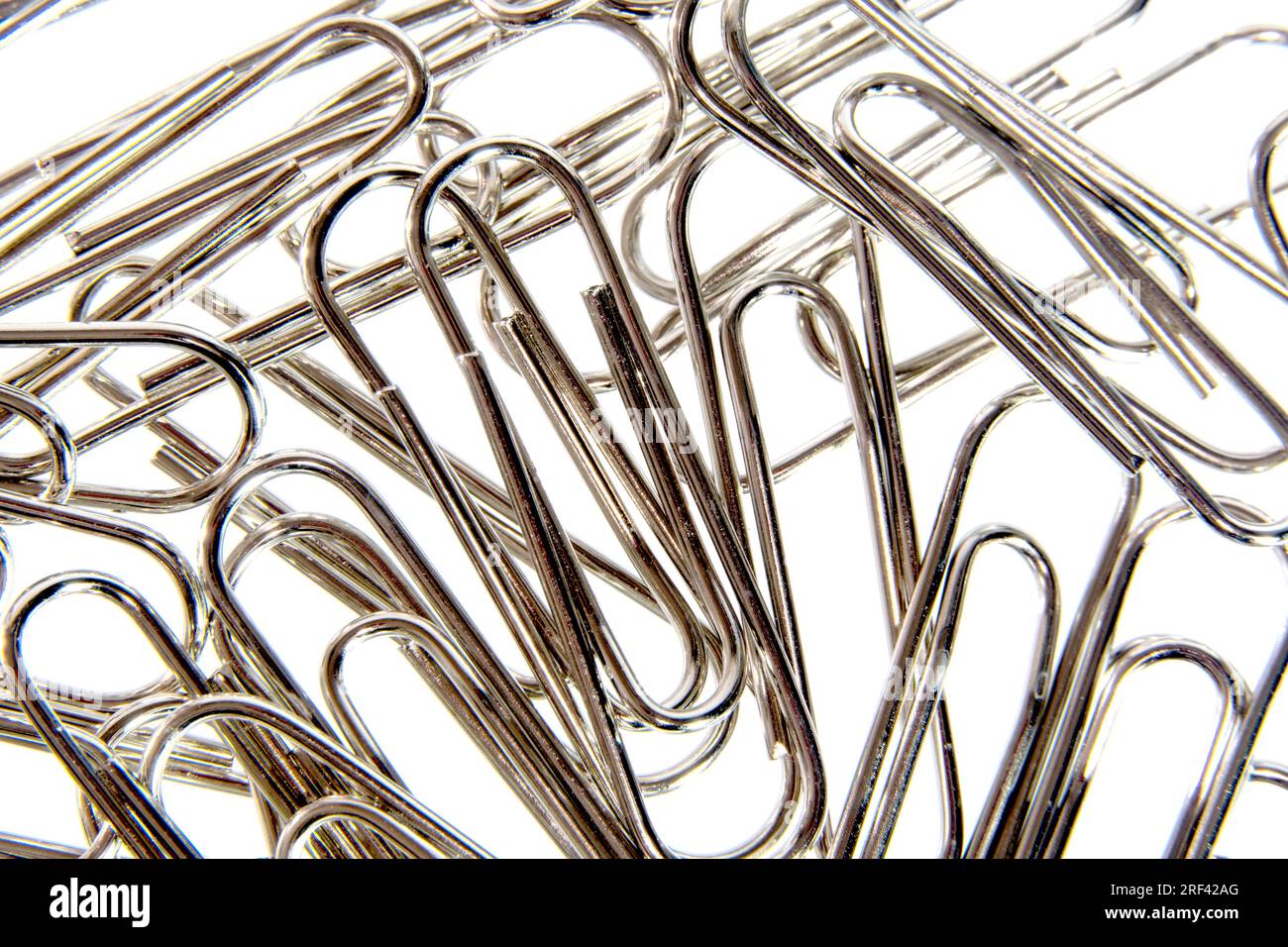Paper clips and office document accessories are isolated on white ...