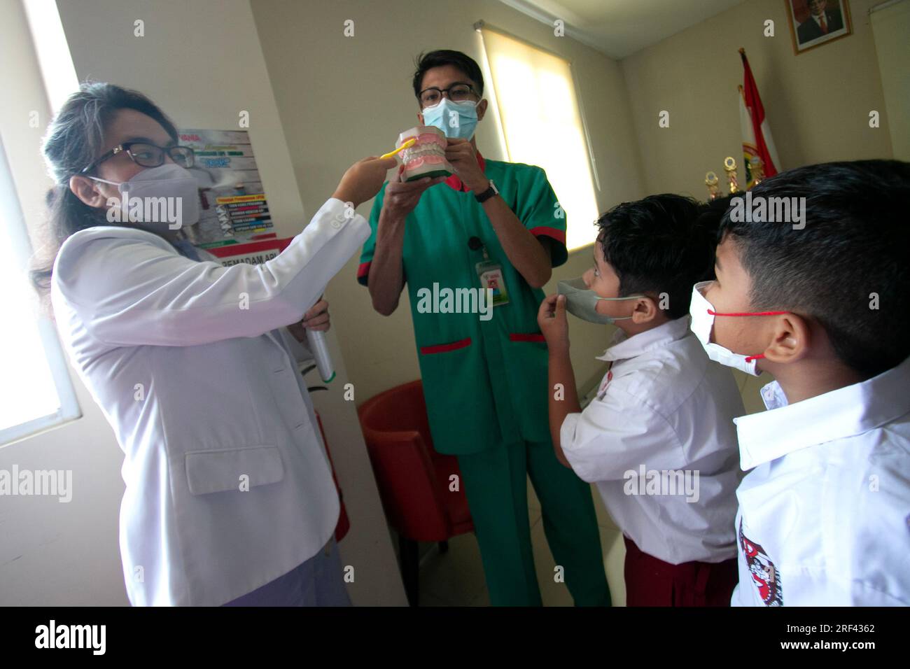 Dentists provide education on how to maintain dental hygiene and health to elementary school ...