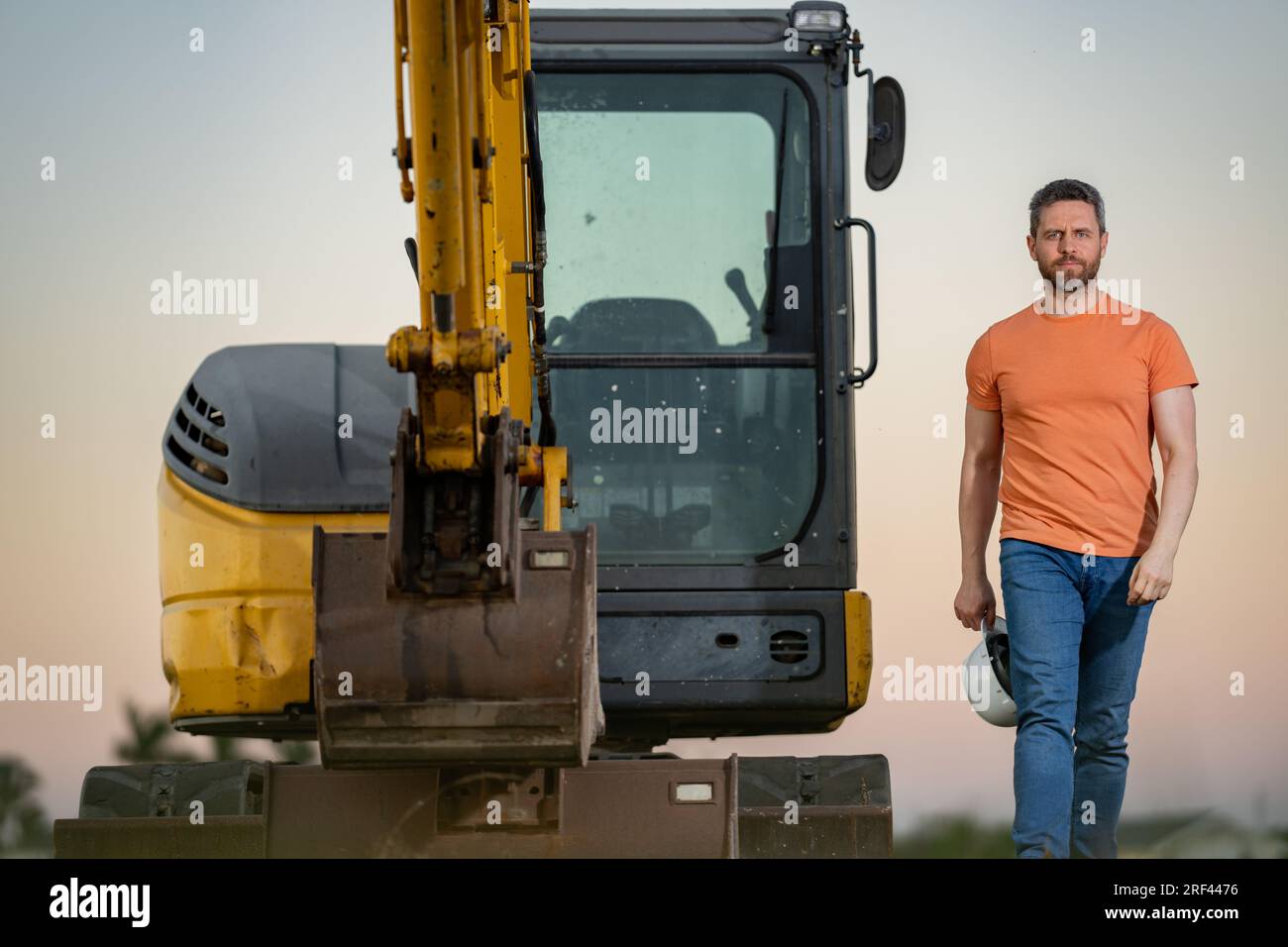 Builder with excavator for construction at the construction site ...
