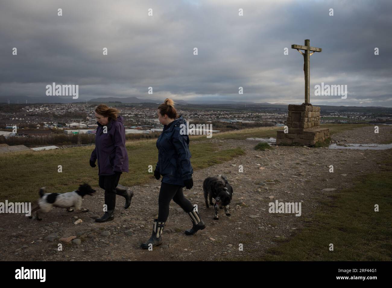 View of the town with crucifix on plinth on coastal cliff top, in ...