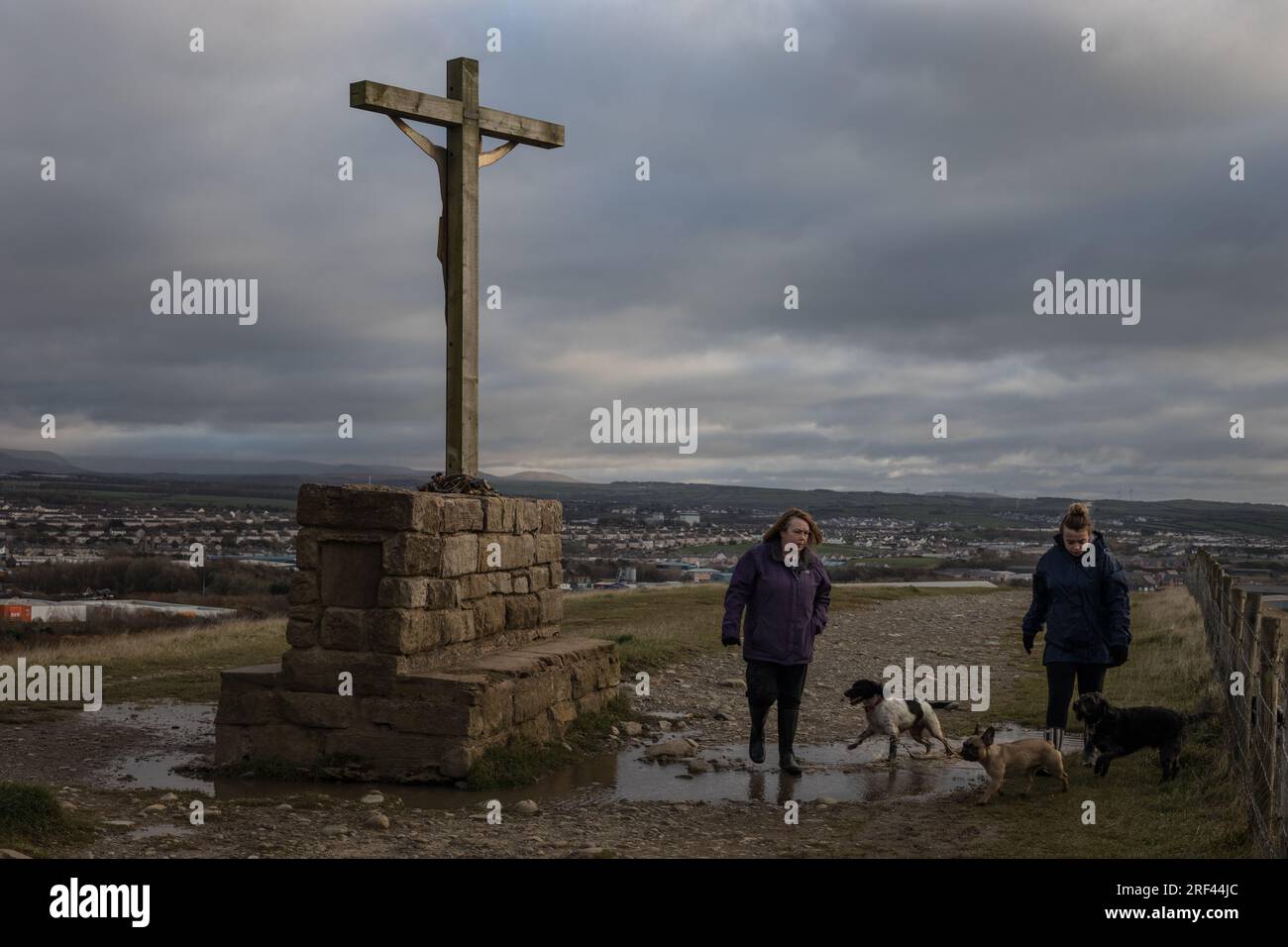 View of the town with crucifix on plinth on coastal cliff top, in ...