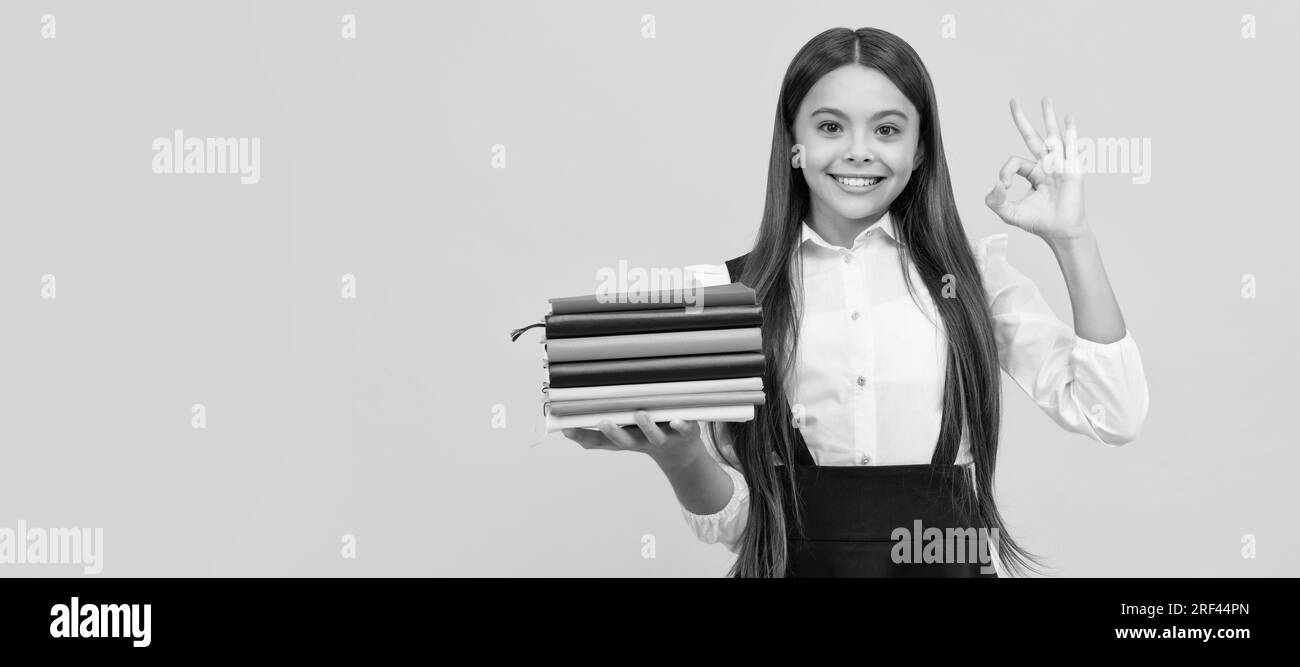 bookish kid in grammar school. happy teen girl hold books heap. perfect ...