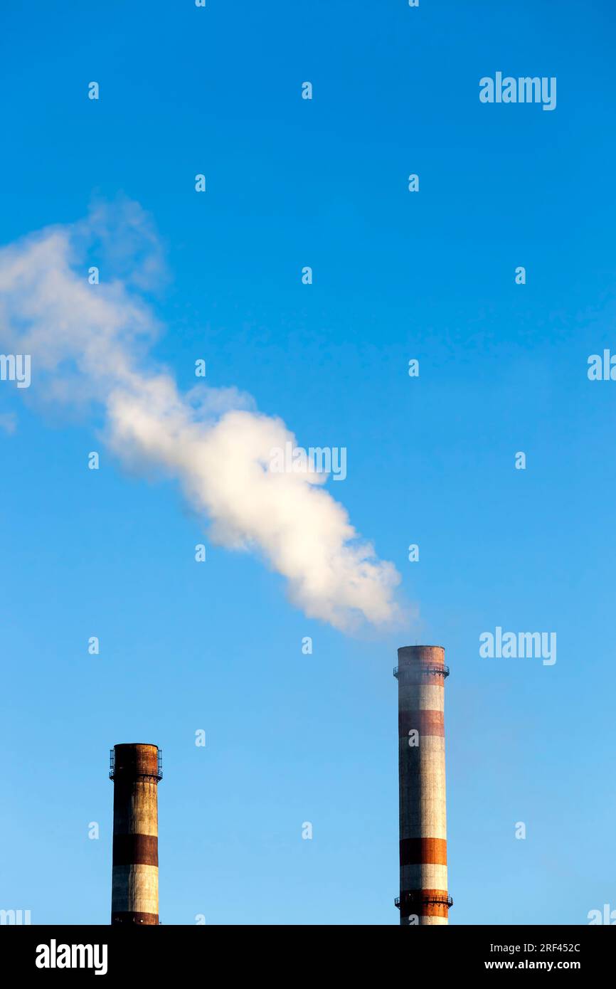 dark smoke comes from the chimney pipe while burning logs or coal to ...