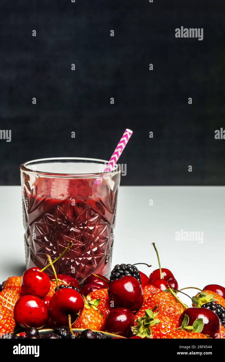 A beautiful cut clear crystal glass filled with red berry detox juice ...