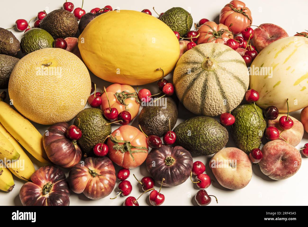 overhead still life with assorted melons, ripe tomatoes, red cherry ...