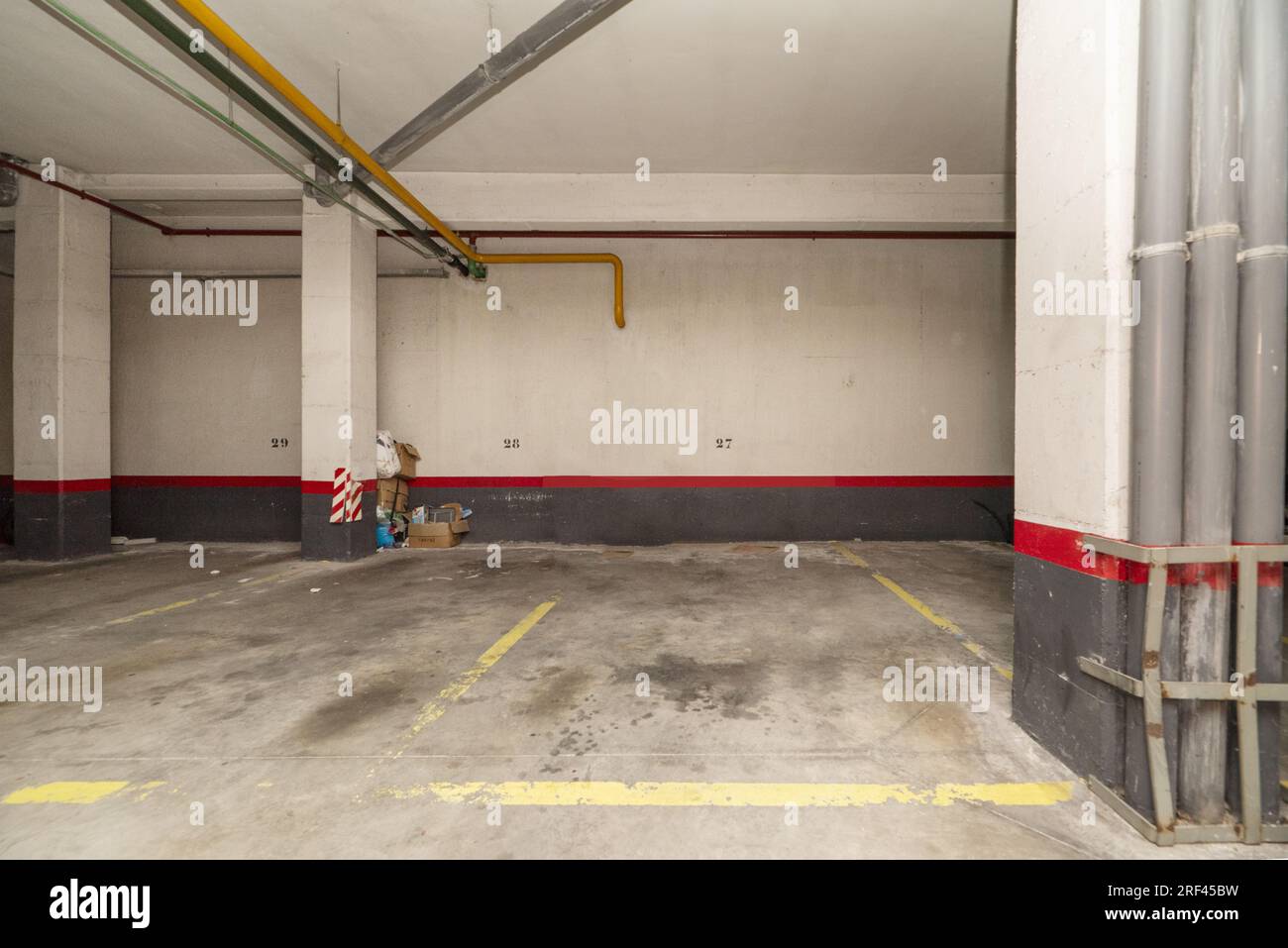 An empty parking space in the basement of an urban residential building ...