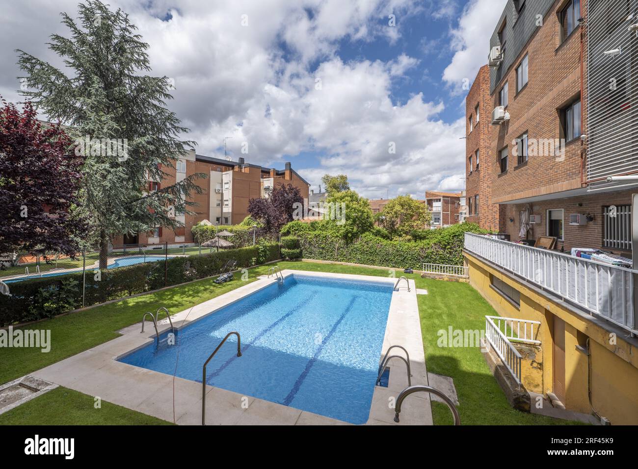 Common areas of an urbanization with a lot of green grass next to a ...