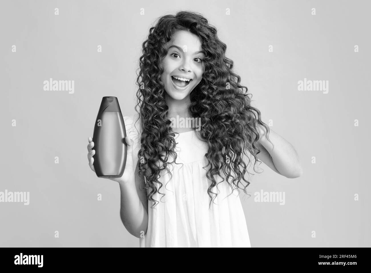 Happy portrait of child teen girl with shampoos conditioners and shower ...