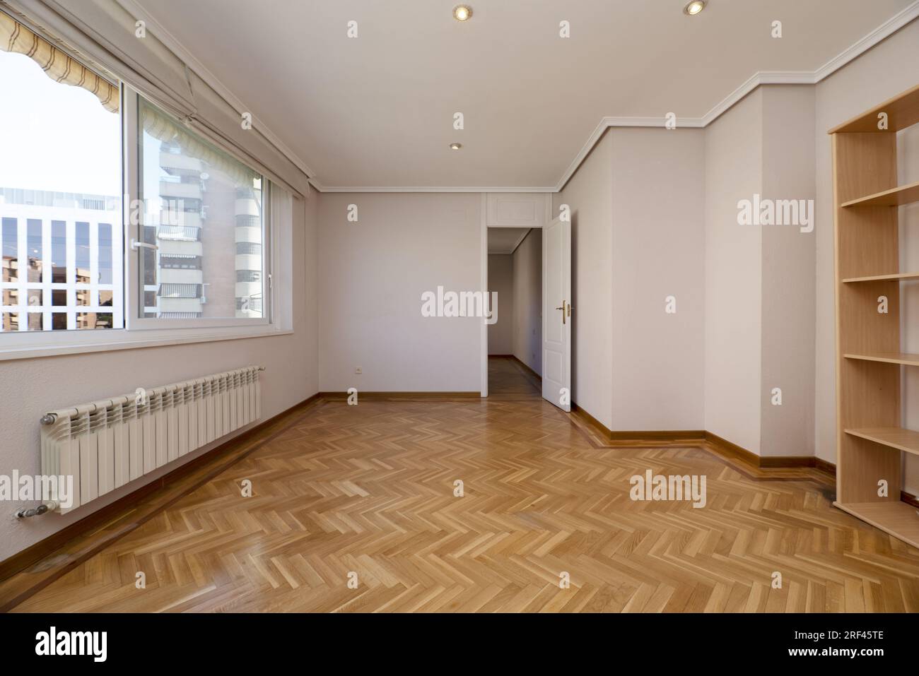 Large living room of a house with parquet floors without furniture ...