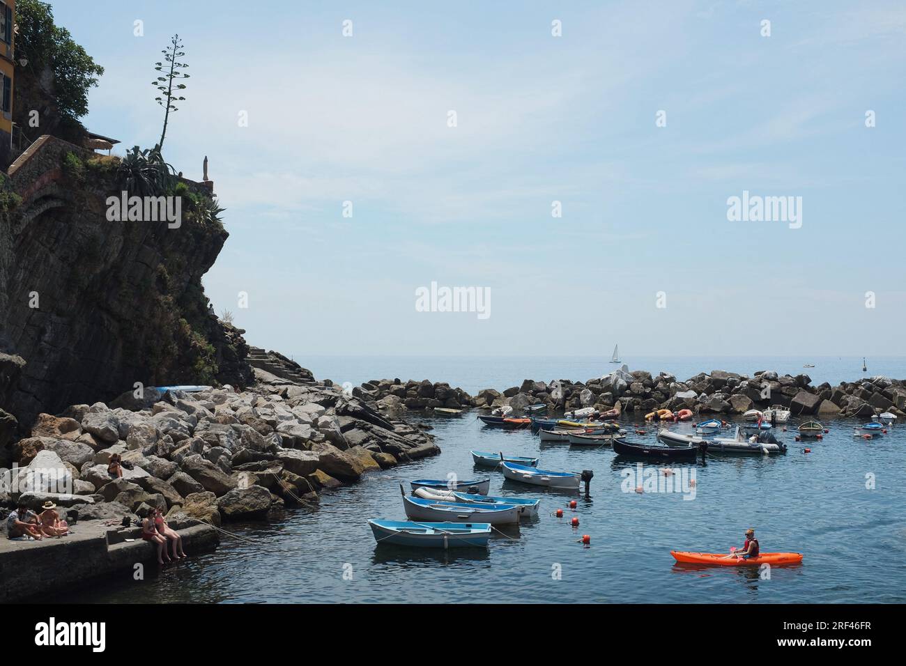 Cinque Terre, Italy - dock in Riomaggiore with boats and tourists in ...