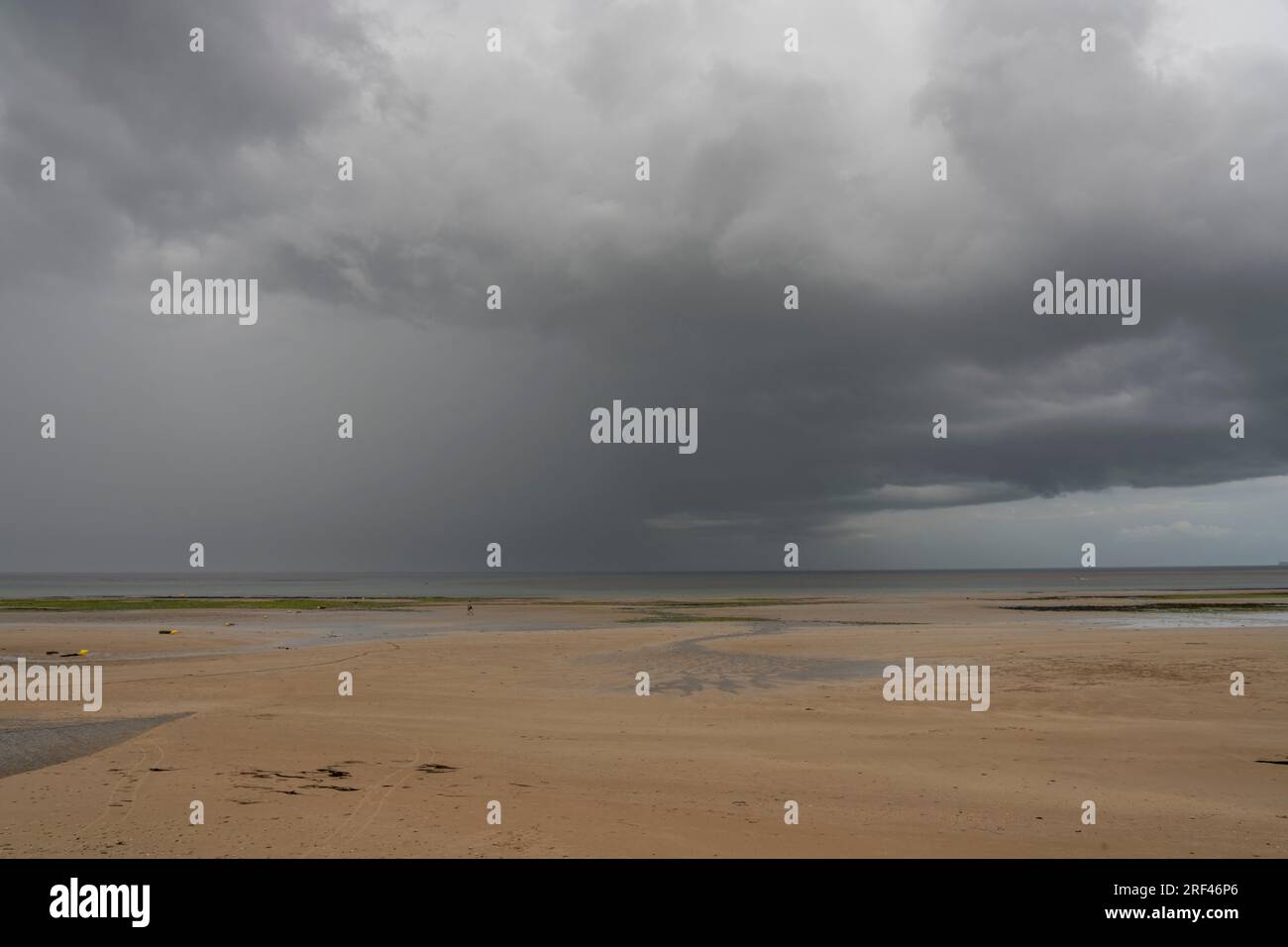 View of a cloudy rainy sky above the sea from the beach Stock Photo - Alamy