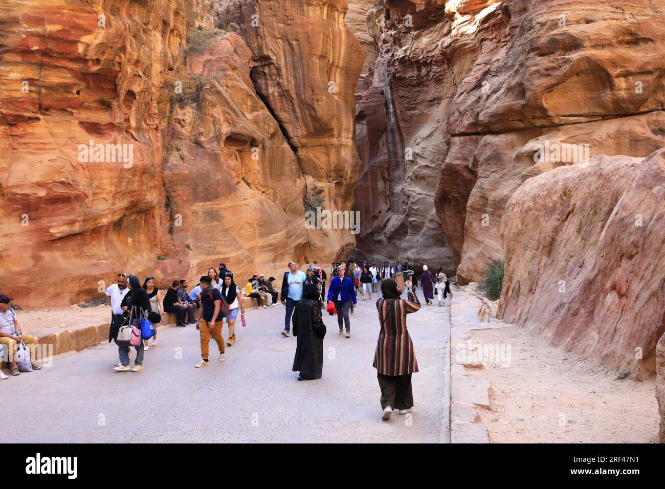 People walking along the Al-Siq, the Main Entrance Canyon to Petra ...