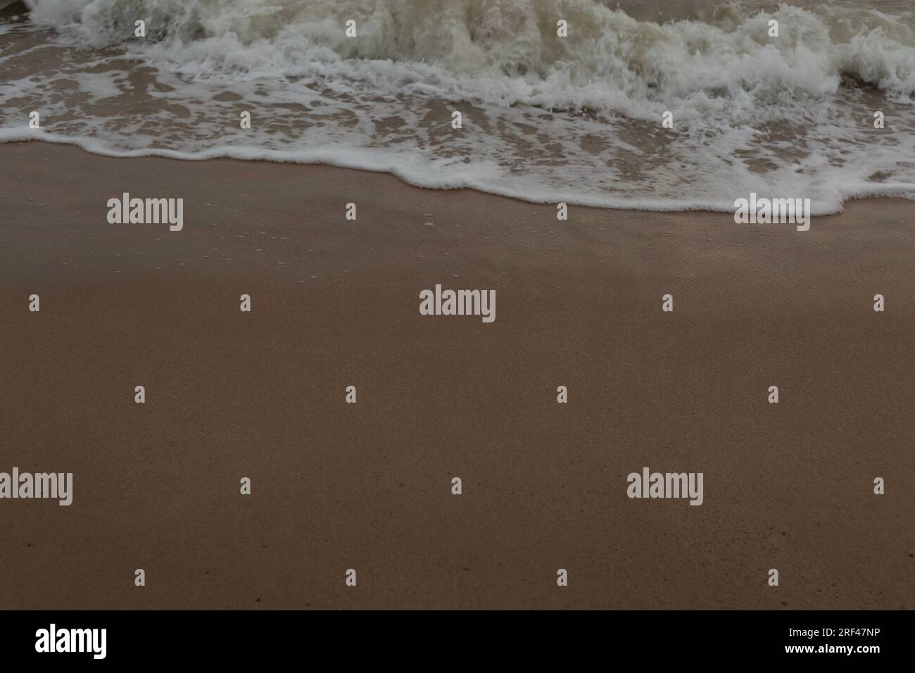 Sea Wave Foam on the Sand Beach Close Up Background Stock Photo - Alamy