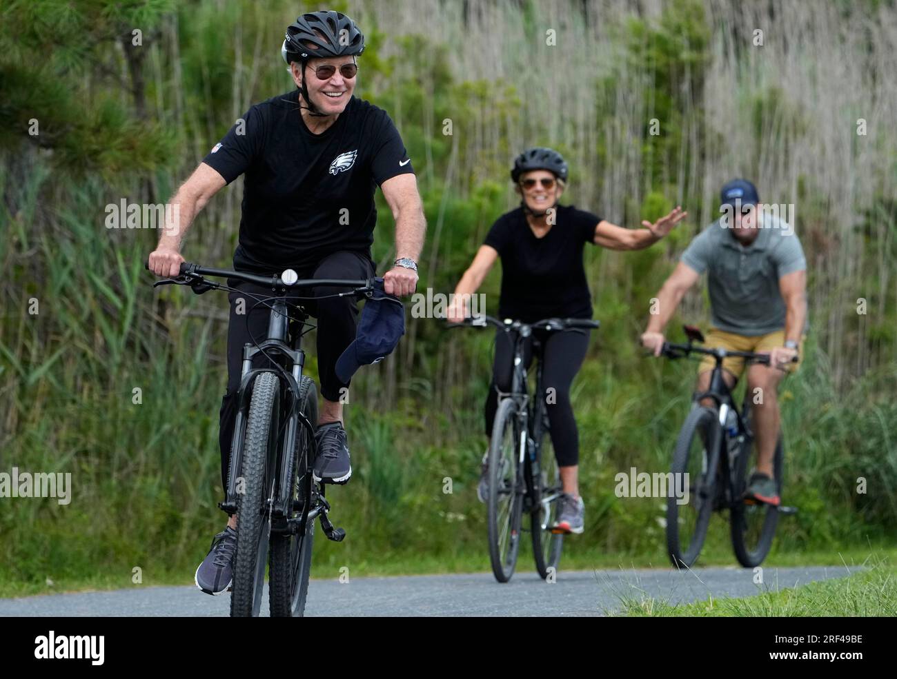President Joe Biden and first lady Jill Biden ride their bikes at ...
