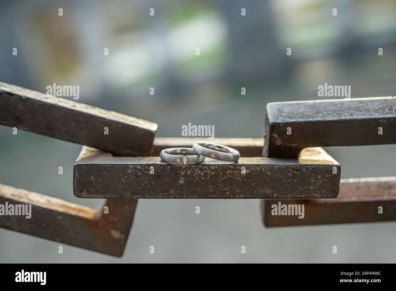 Two hands with wedding rings rest on a strong anchor chain Stock Photo ...