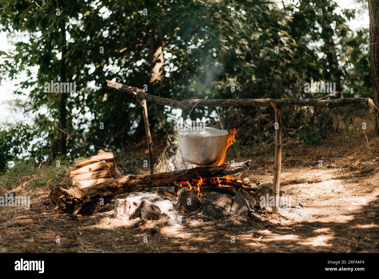 Old pot cooking over campfire hi-res stock photography and images - Alamy
