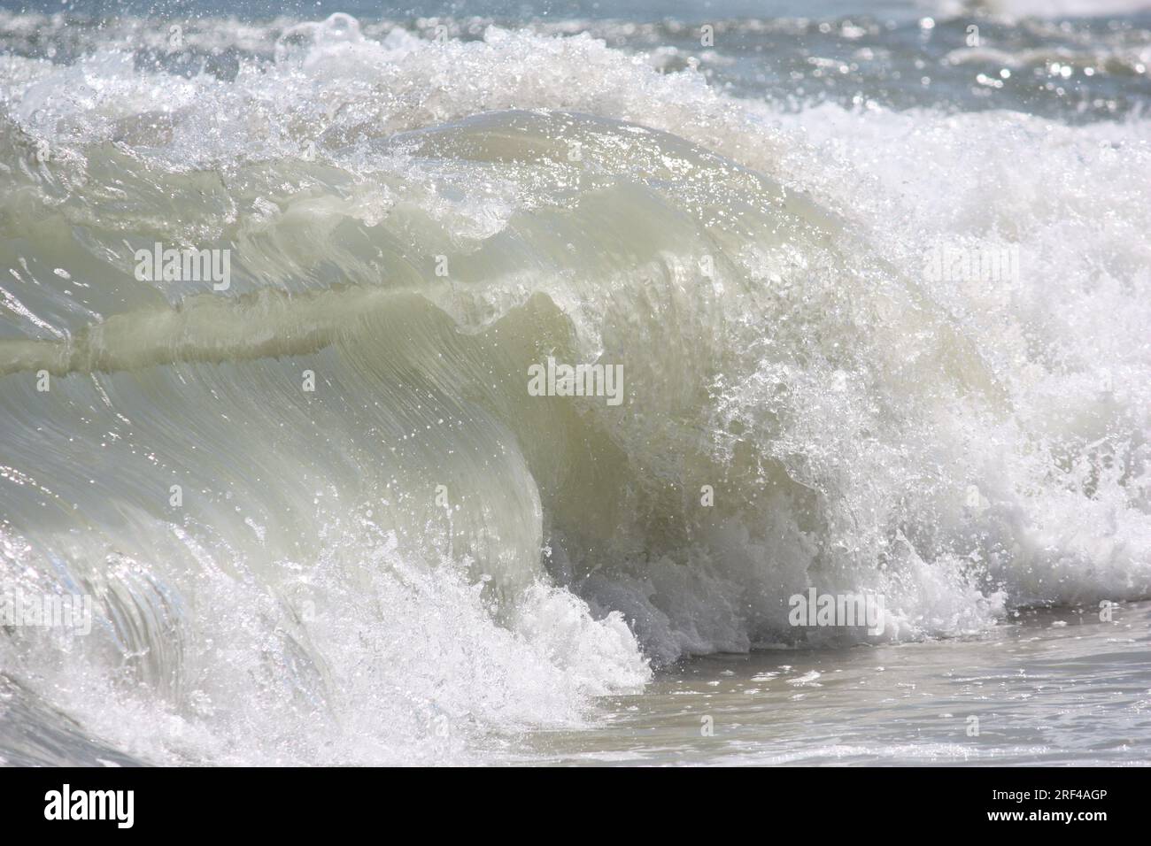 A wave rolls over another wave Stock Photo - Alamy