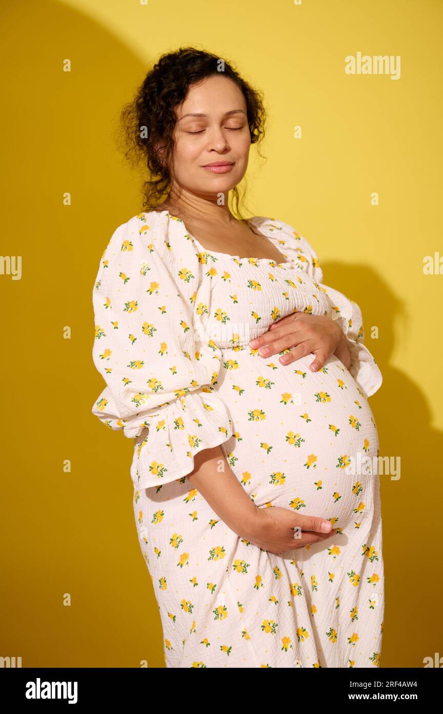 Happy pregnant woman, gravid expectant mother in stylish white summer ...