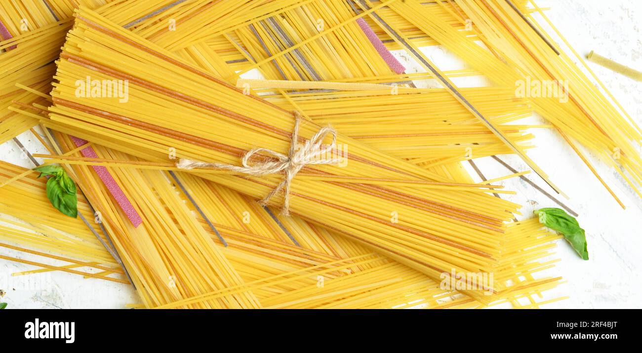 Many raw spaghetti on white background Stock Photo - Alamy